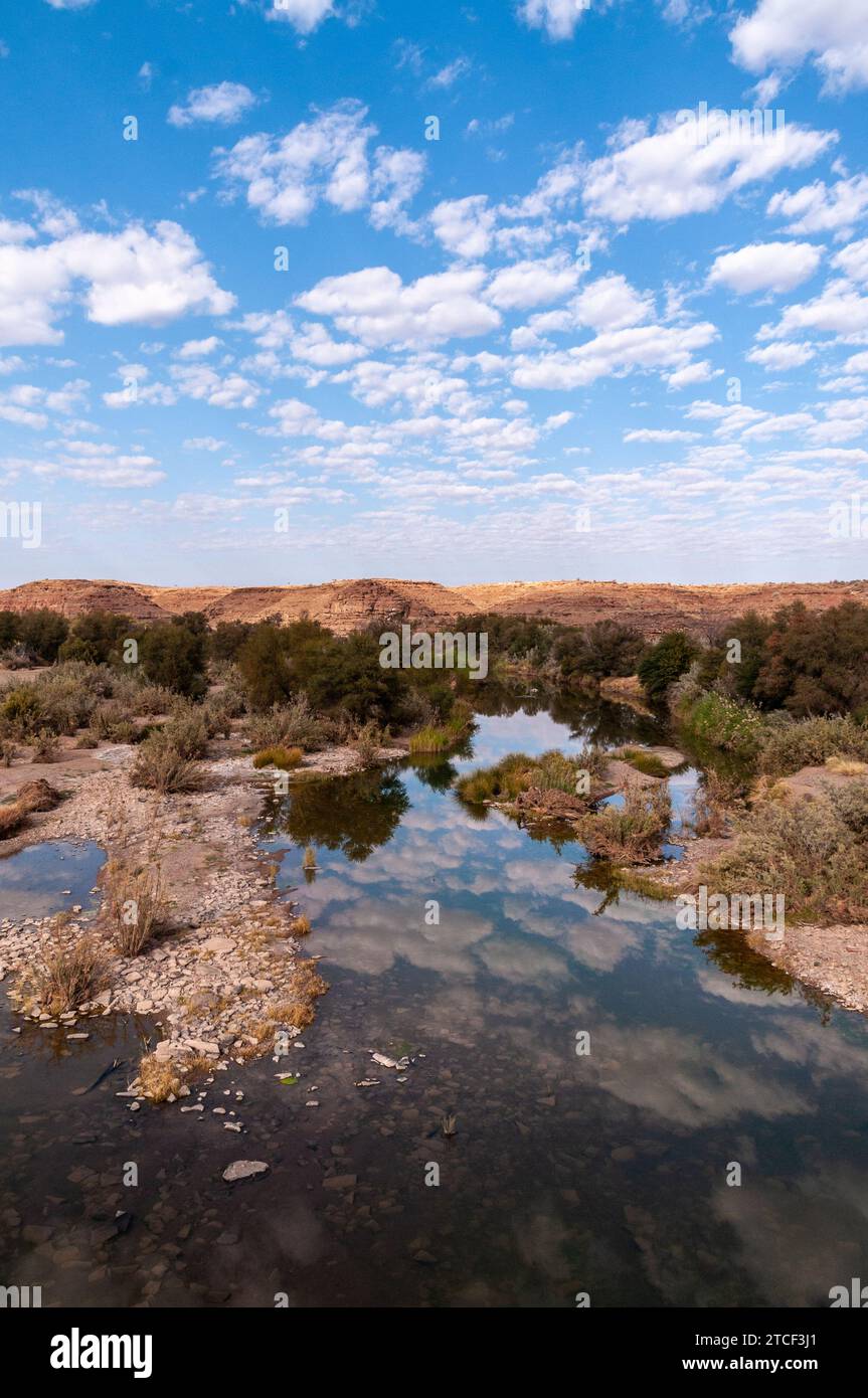 Low hanging clouds are reflected in a water of the Fish river in ...