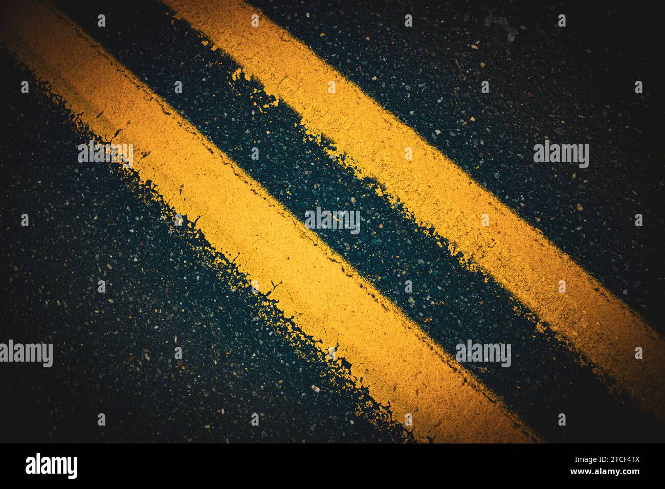 A closeup of a two-lane asphalt road, with the right lane painted in a ...