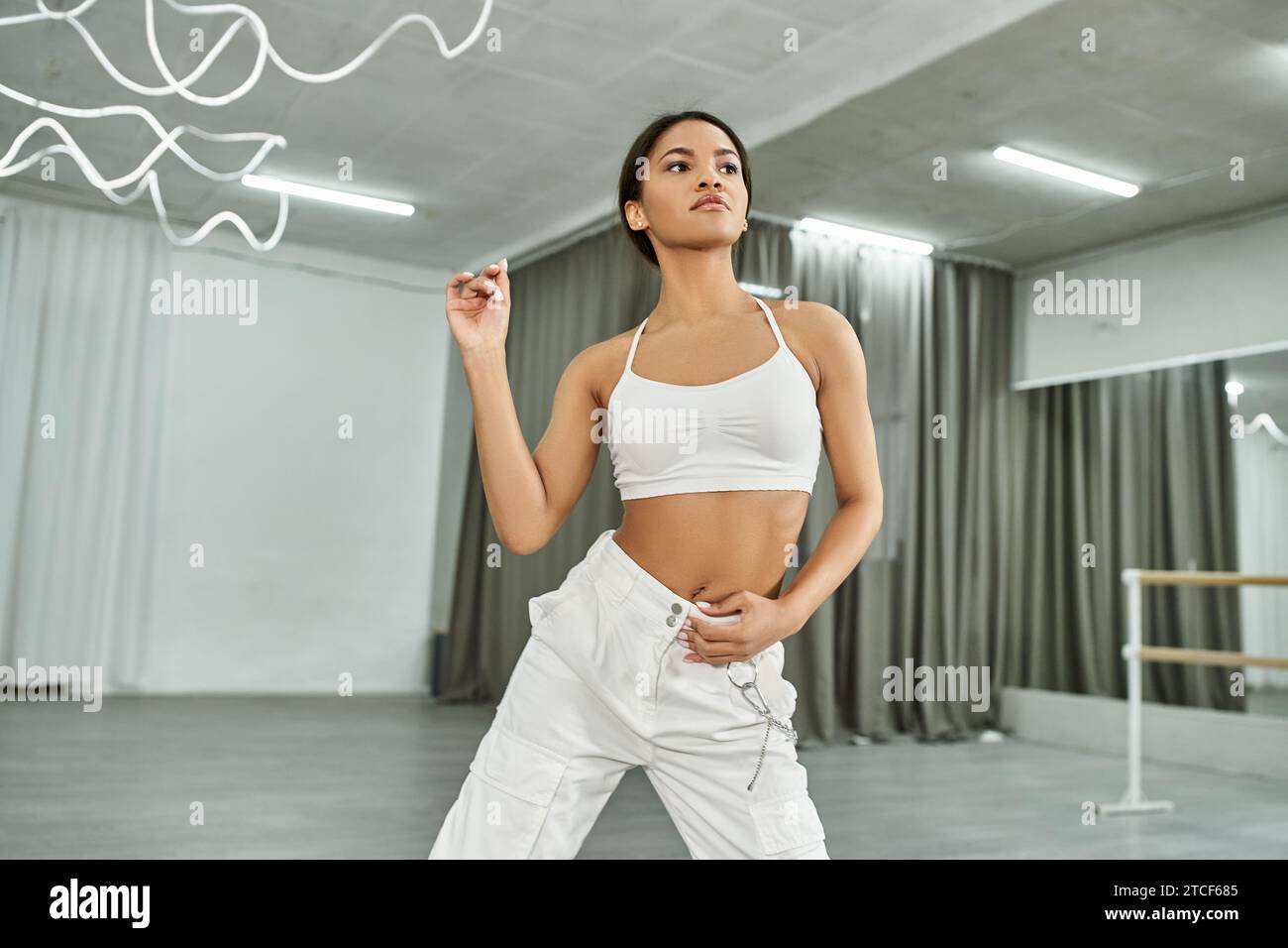 rhythmic african american dancer in white sports top and jogger pants ...