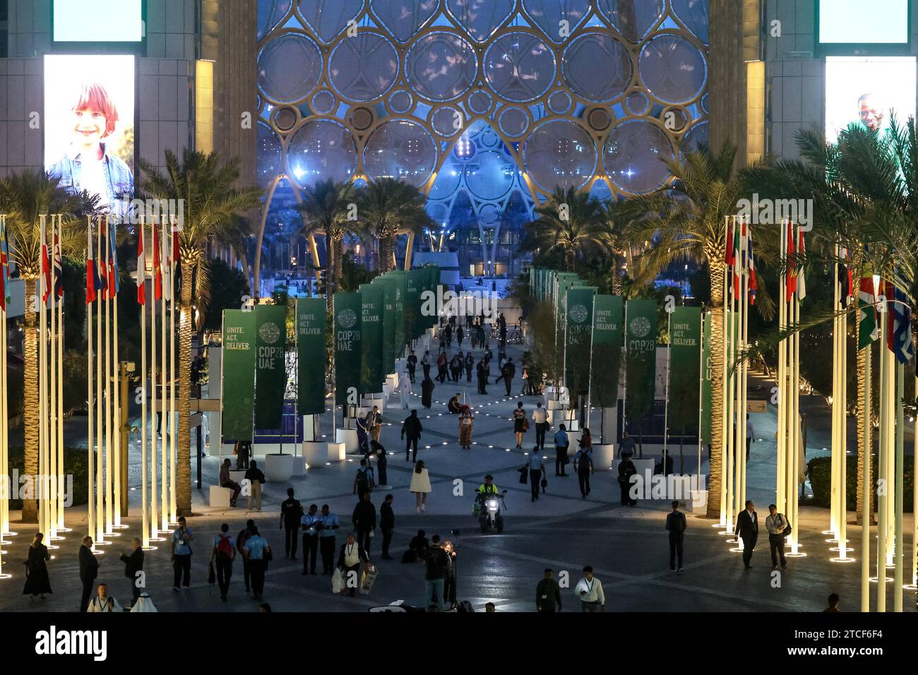 Participants walk on Al Wasl Avenue on the last day of COP28, UN ...