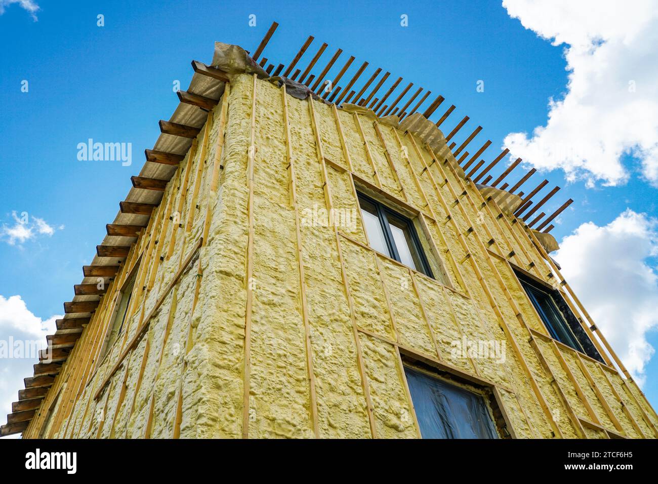 The facade of the residential house sprayed with a layer of polyurethane thermal insulation foam ...