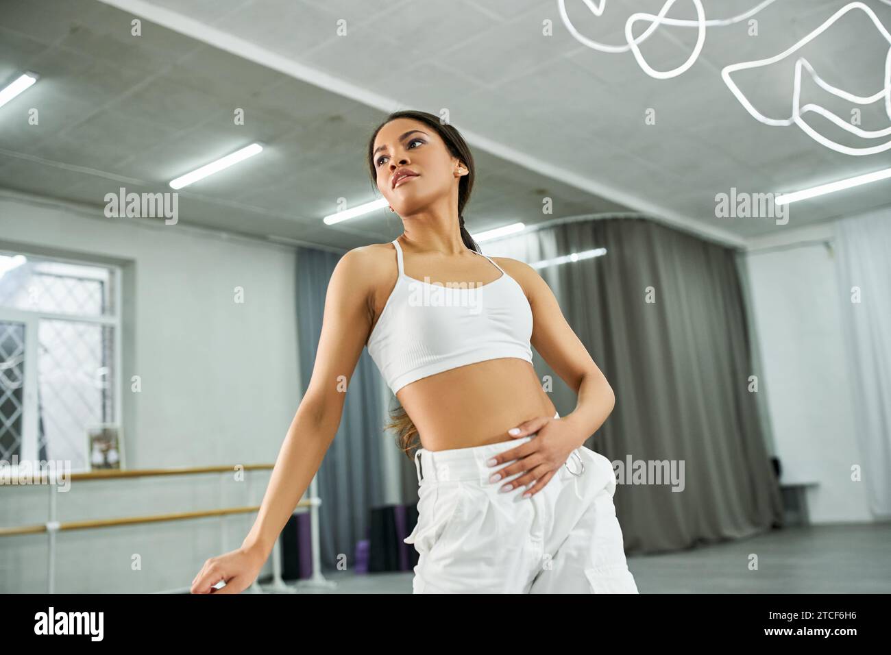 confident african american female dancer in white sports top and pants ...