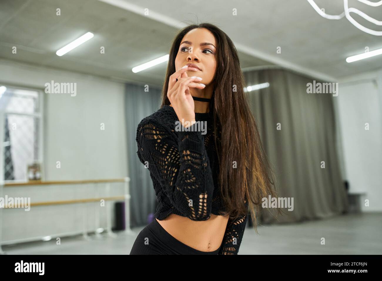 attractive african american dancer in black attire rehearsing in dance ...
