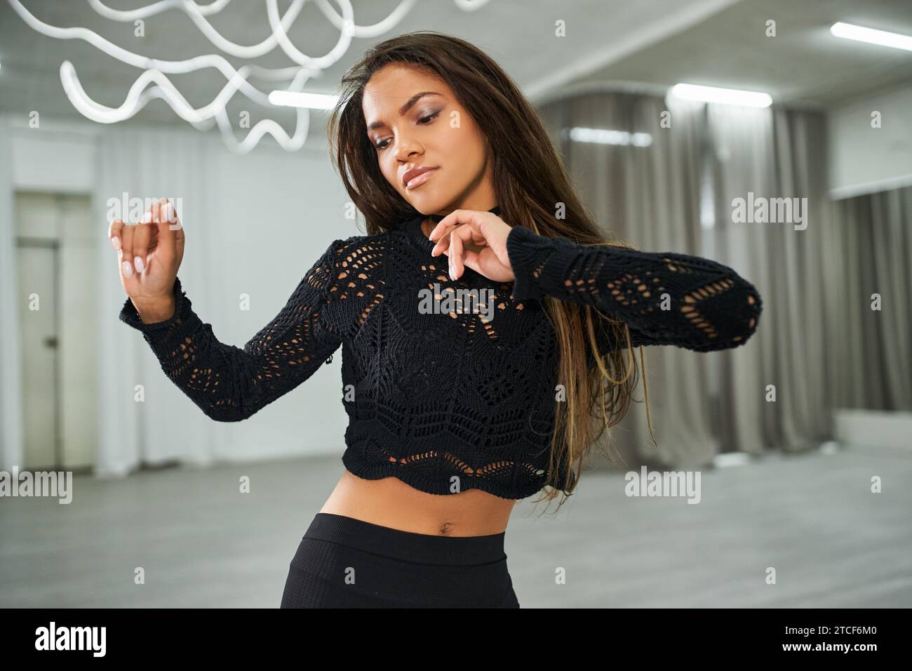 expressive african american dancer in black knitted sweater rehearsing ...
