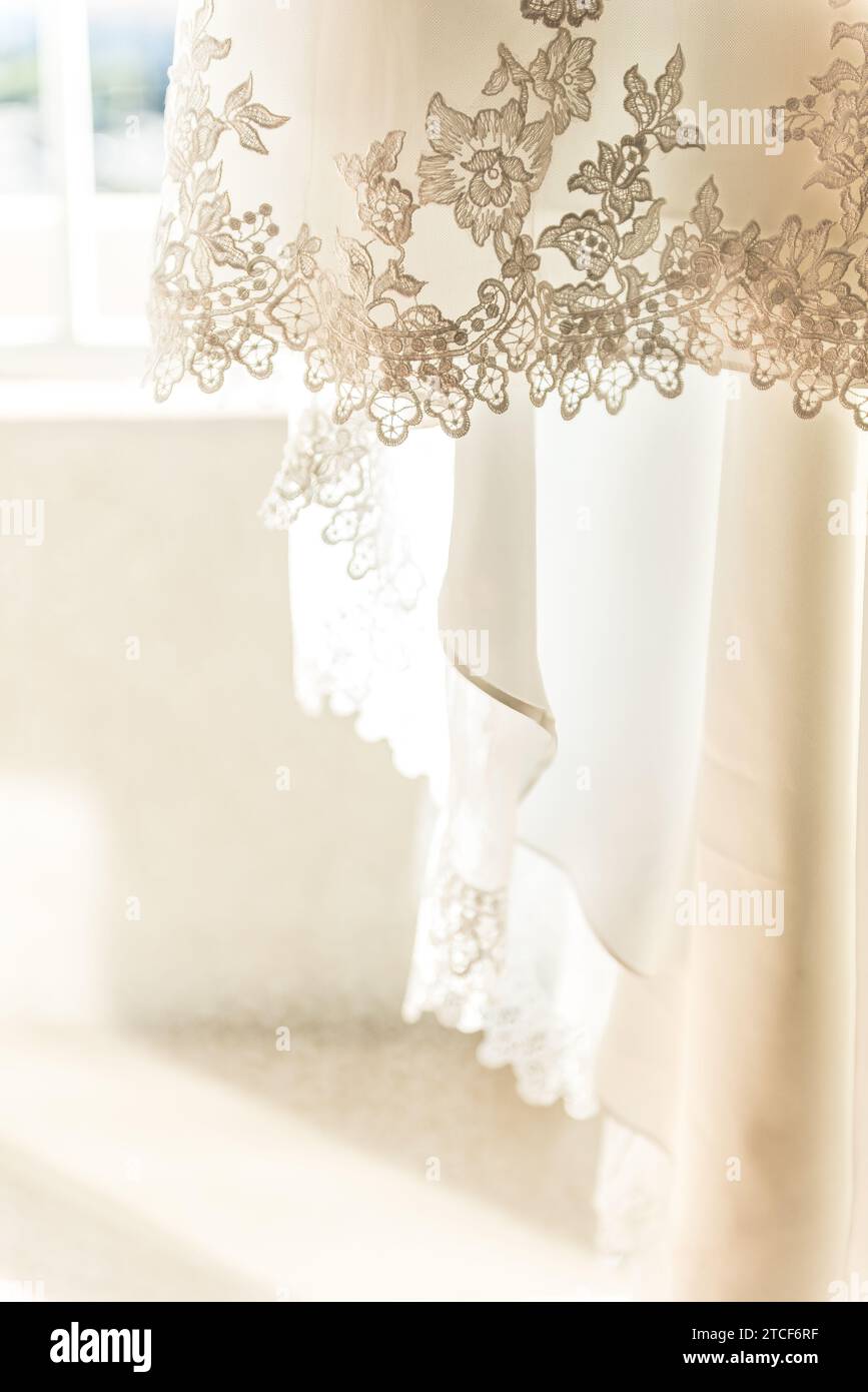 A Bottom of a laced white wedding dress Stock Photo - Alamy