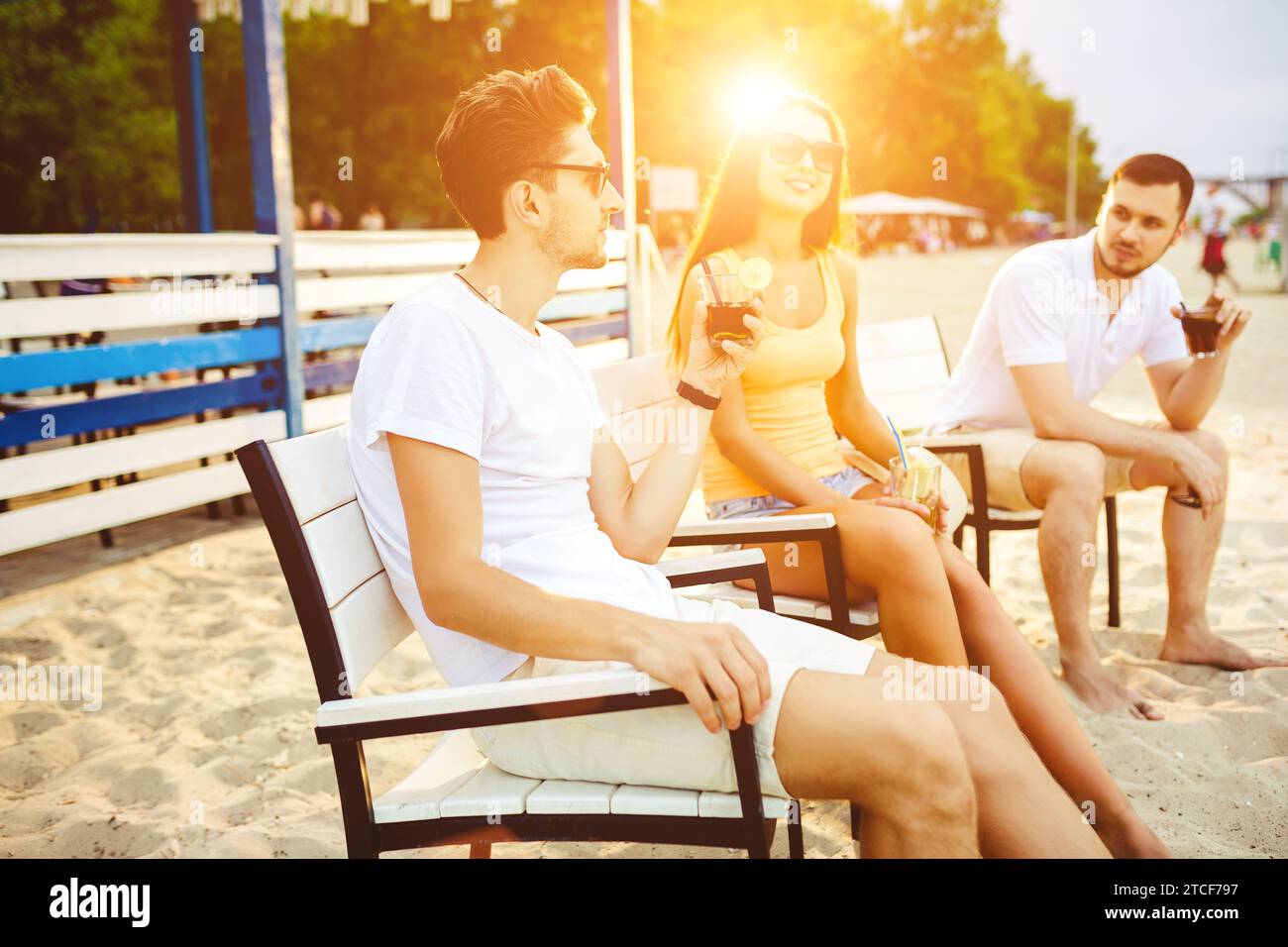 Young people enjoying summer vacation sunbathing drinking at beach bar ...
