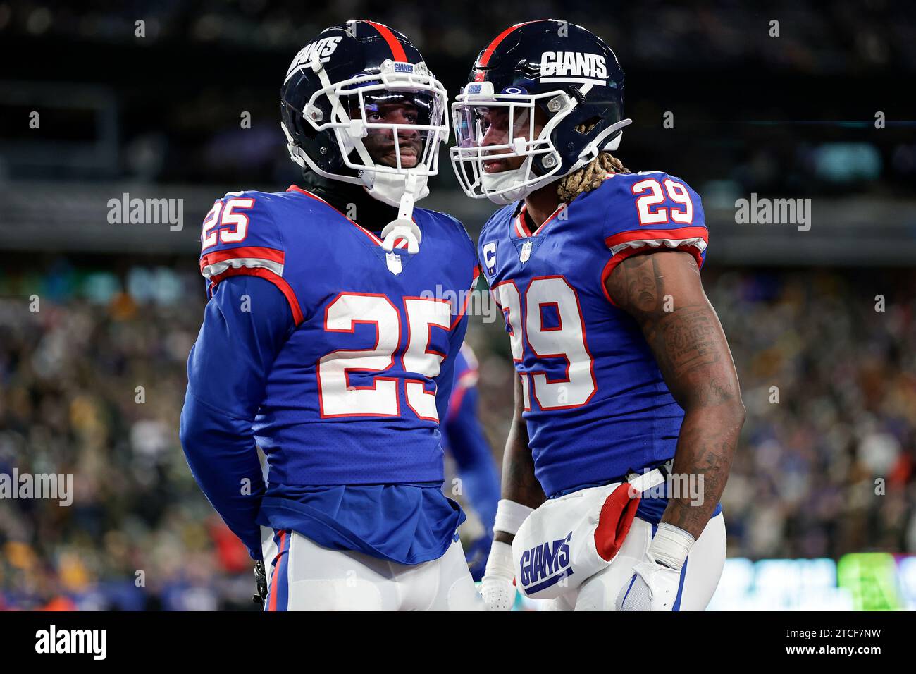 New York Giants cornerback Deonte Banks (25) talks with safety Xavier McKinney (29) during the ...