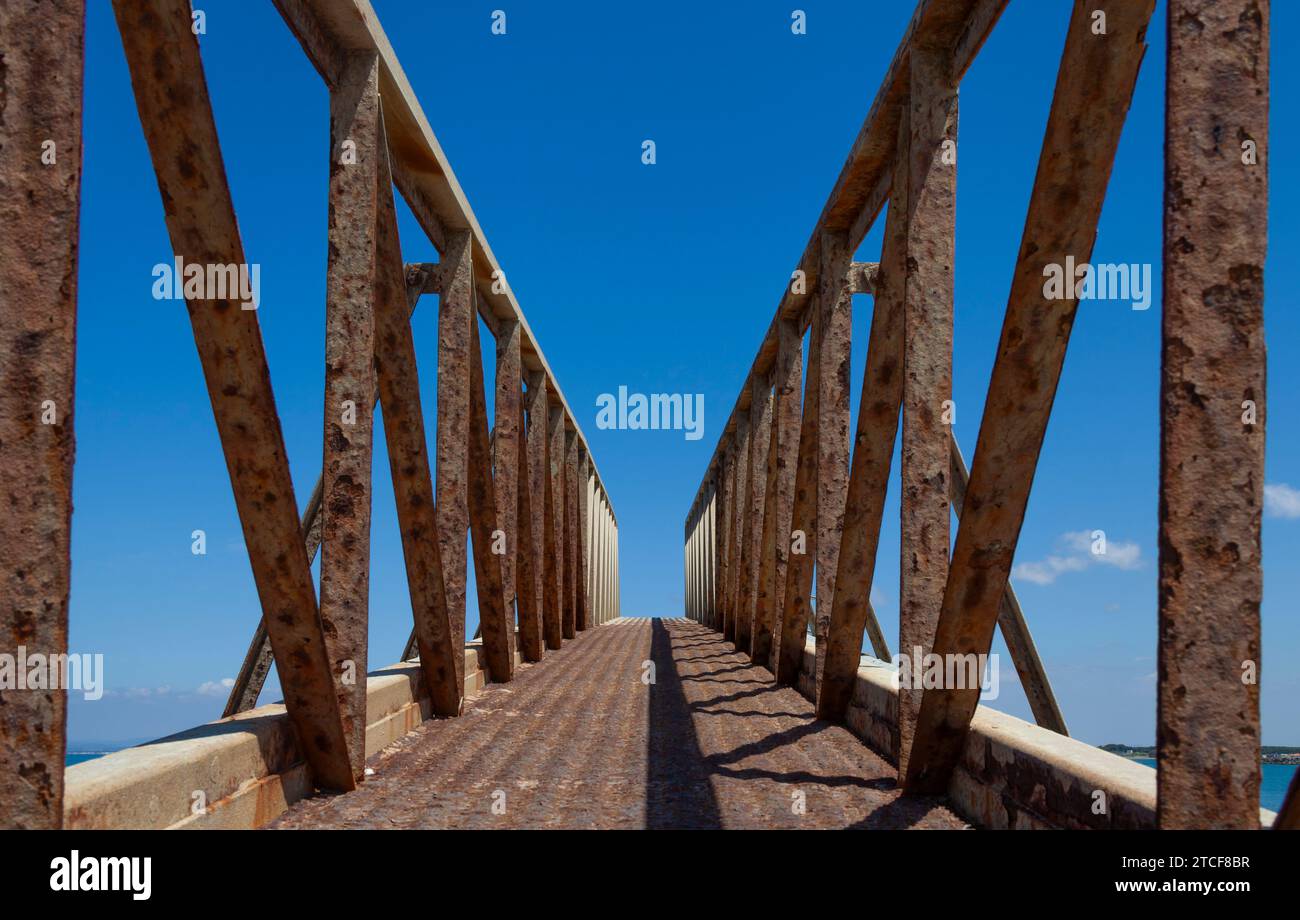Raised iron bridge at Fiumicino port, worn by weather, lines converging ...