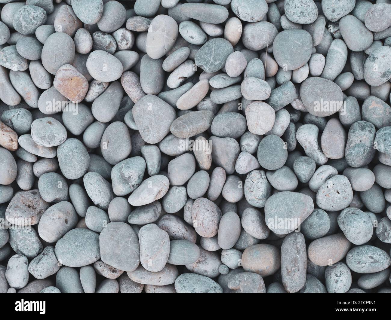 Round beach stones background Stock Photo - Alamy