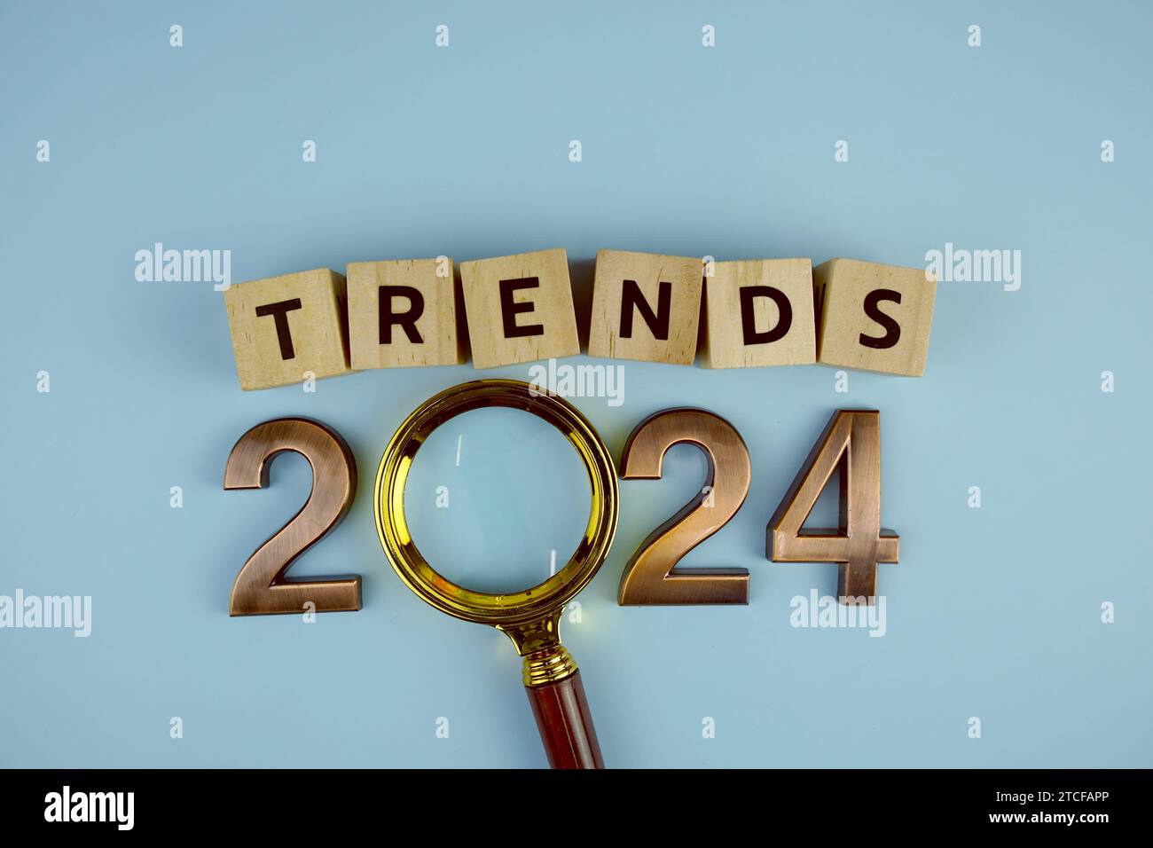 Trends of 2024 alphabet letters with magnifying glass on blue ...