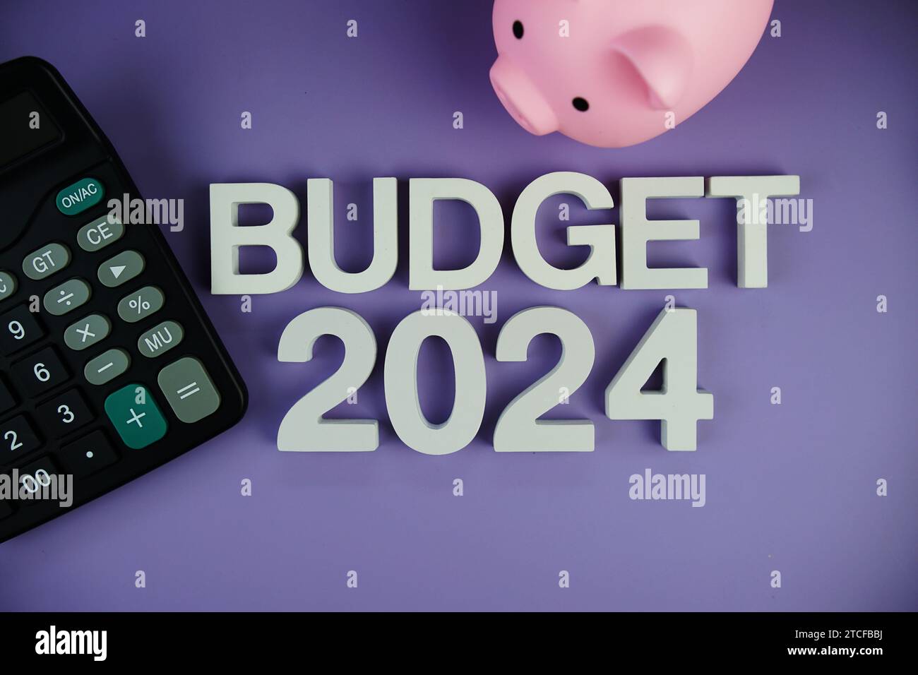 Budget 2024 alphabet letters with piggy bank and calculator top view on ...