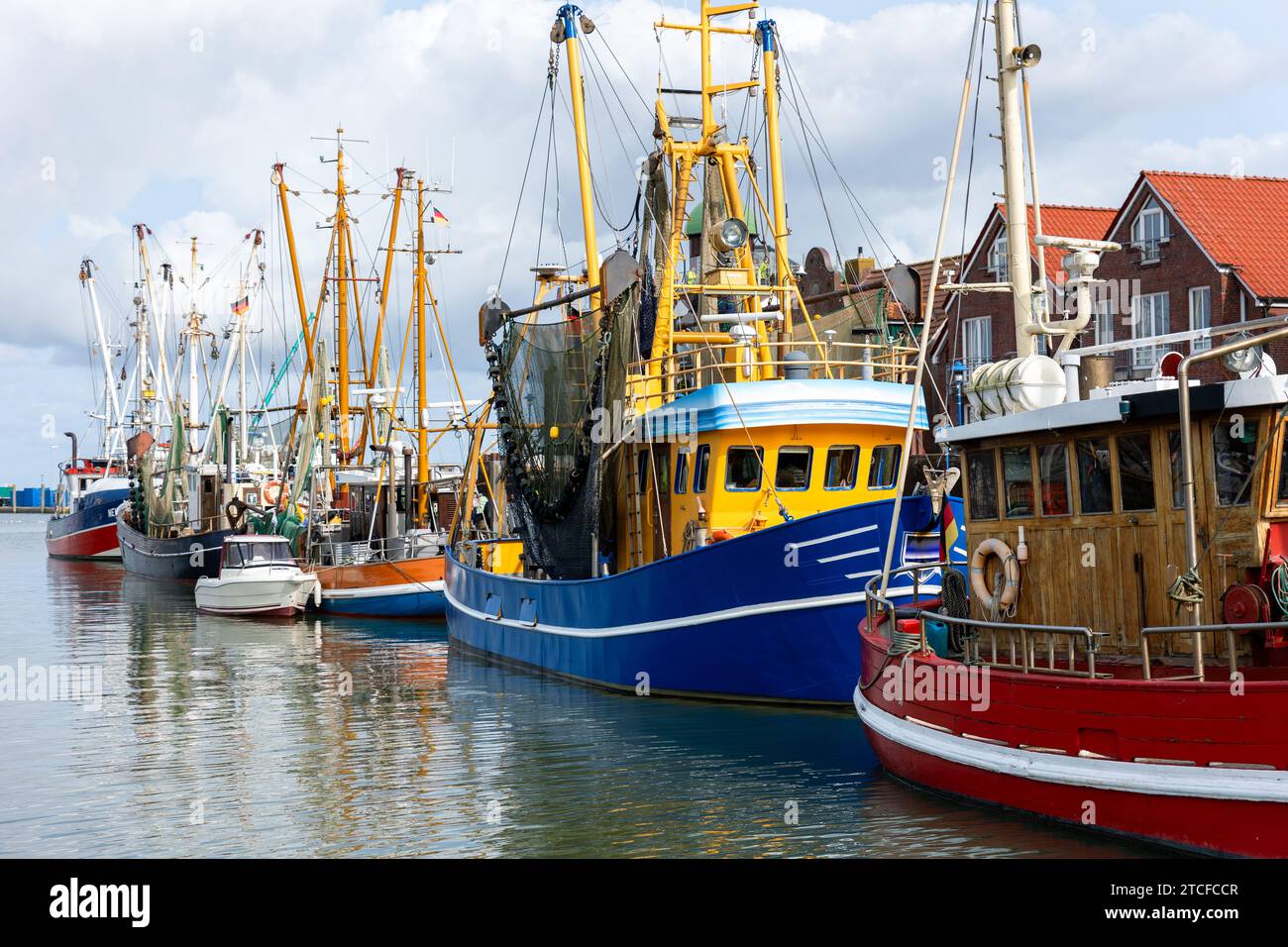 Colorful traditional old german fishing cutter boats moored ...