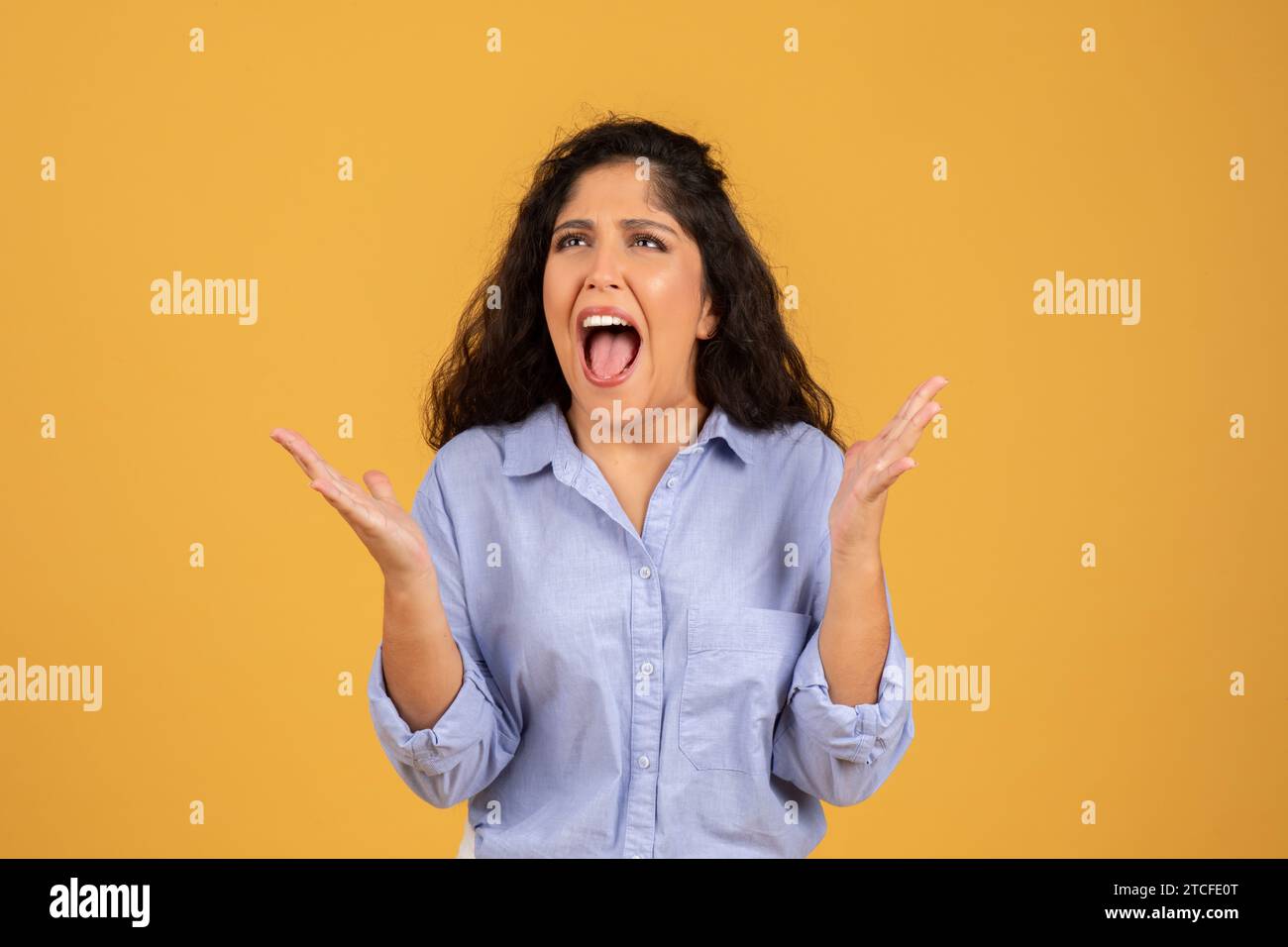 Sad despaired latin young brunette lady in casual with open mouth ...