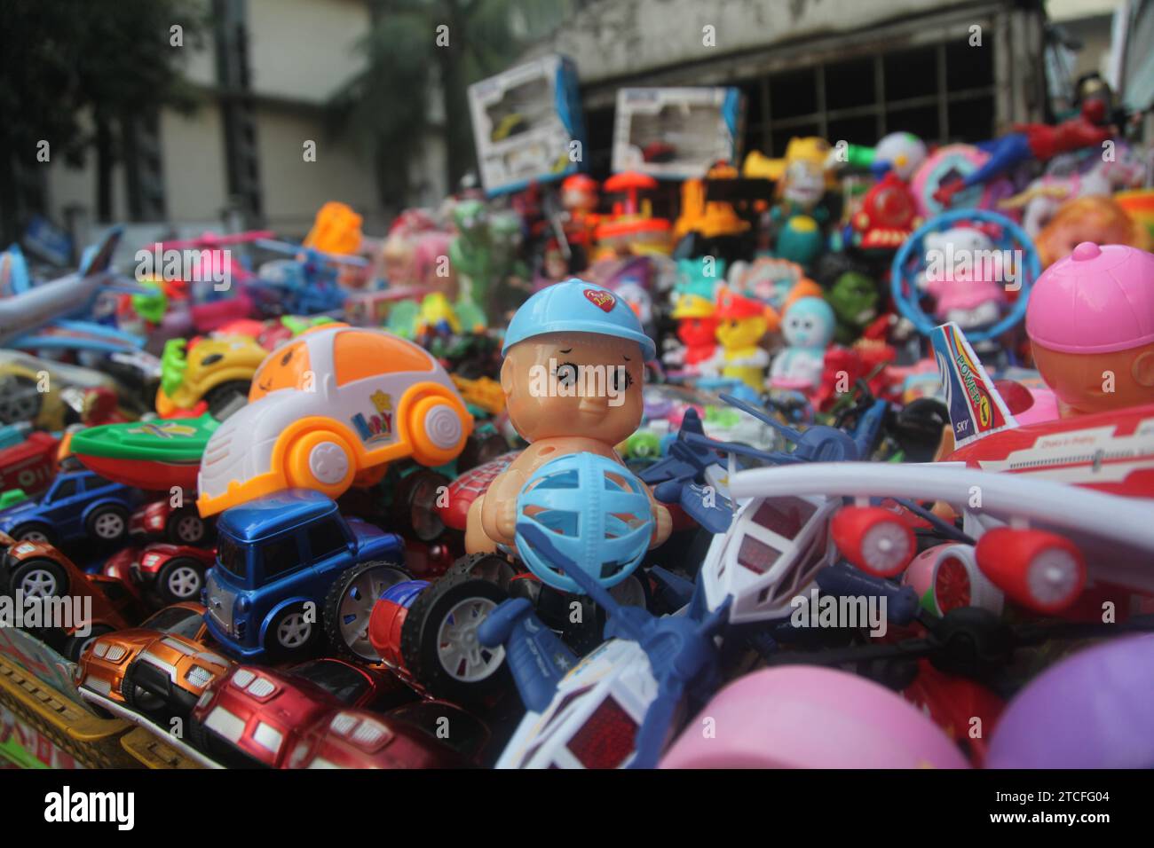 Dhaka Bangladesh 12December 2023, street vendor selling colorful plastic toys by the roadside ...