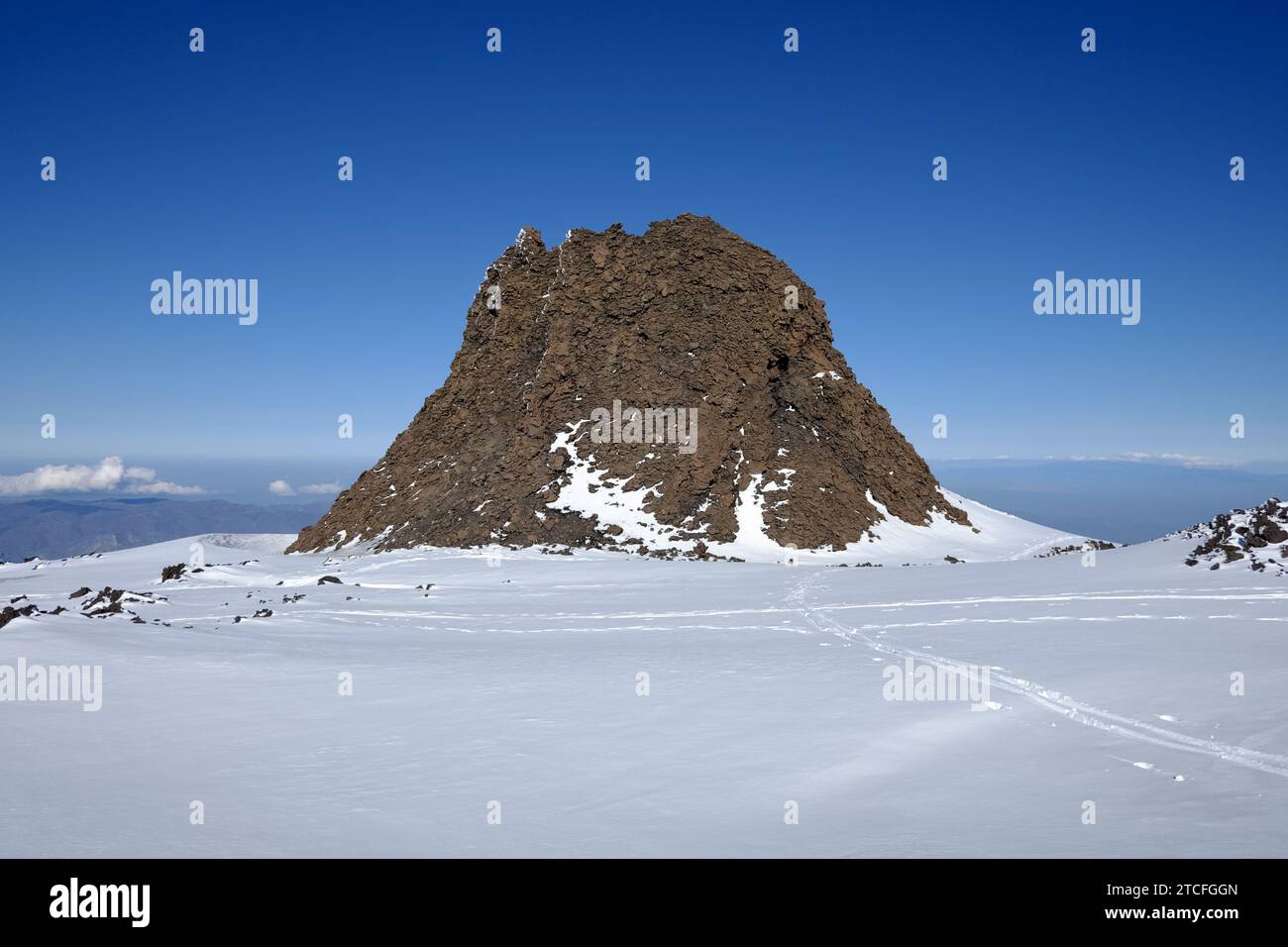 snowy lava field with a hornito on mountainside of Mount Etna North ...