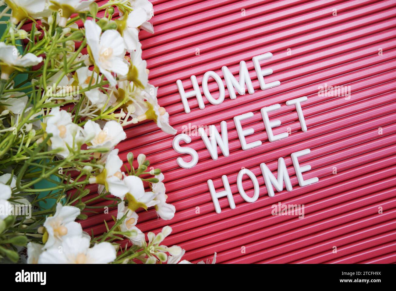 Home Sweet Home text on Letter Board with flower decoration Stock Photo ...