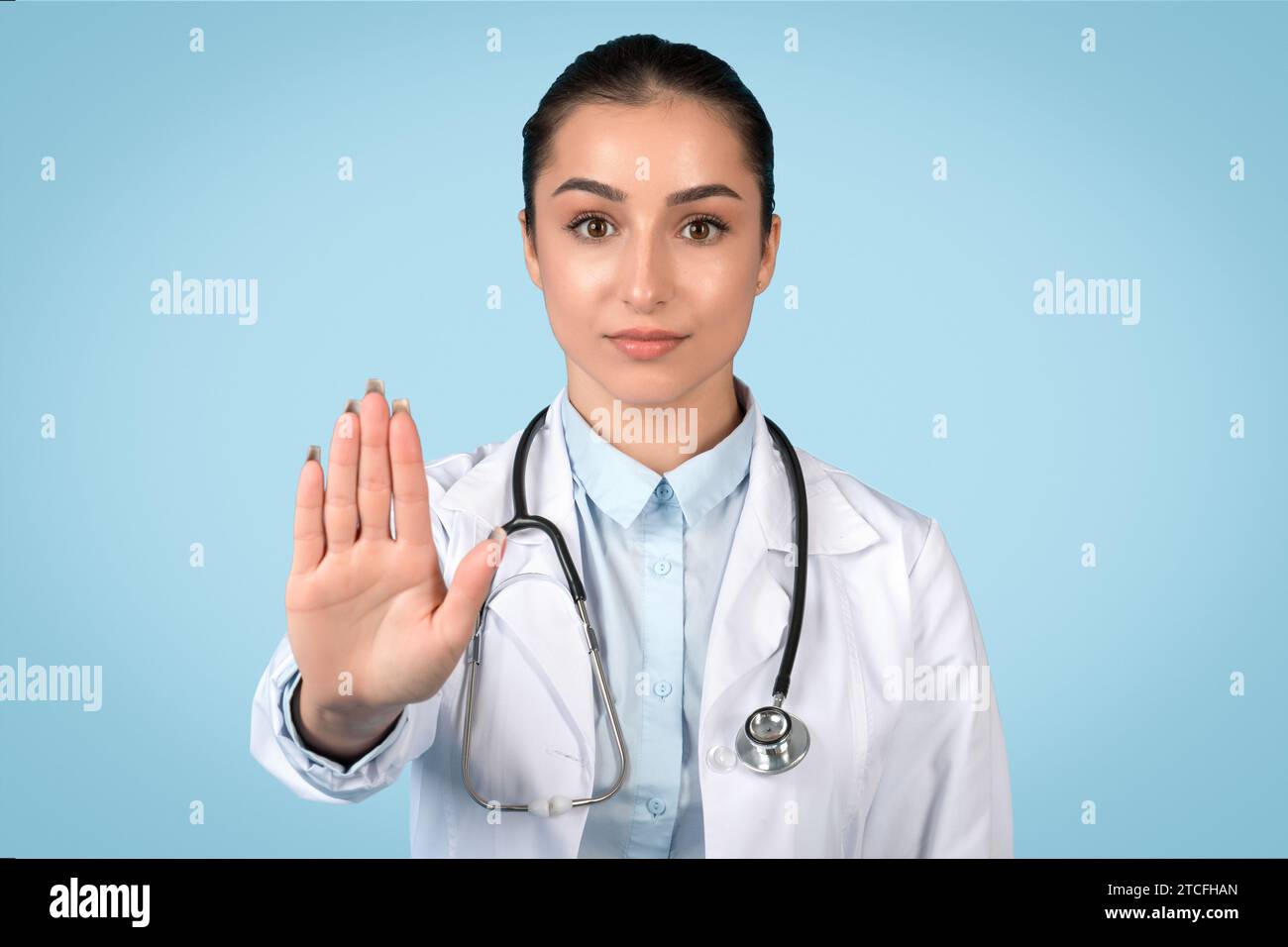 Woman doctor giving stop sign with hand Stock Photo - Alamy