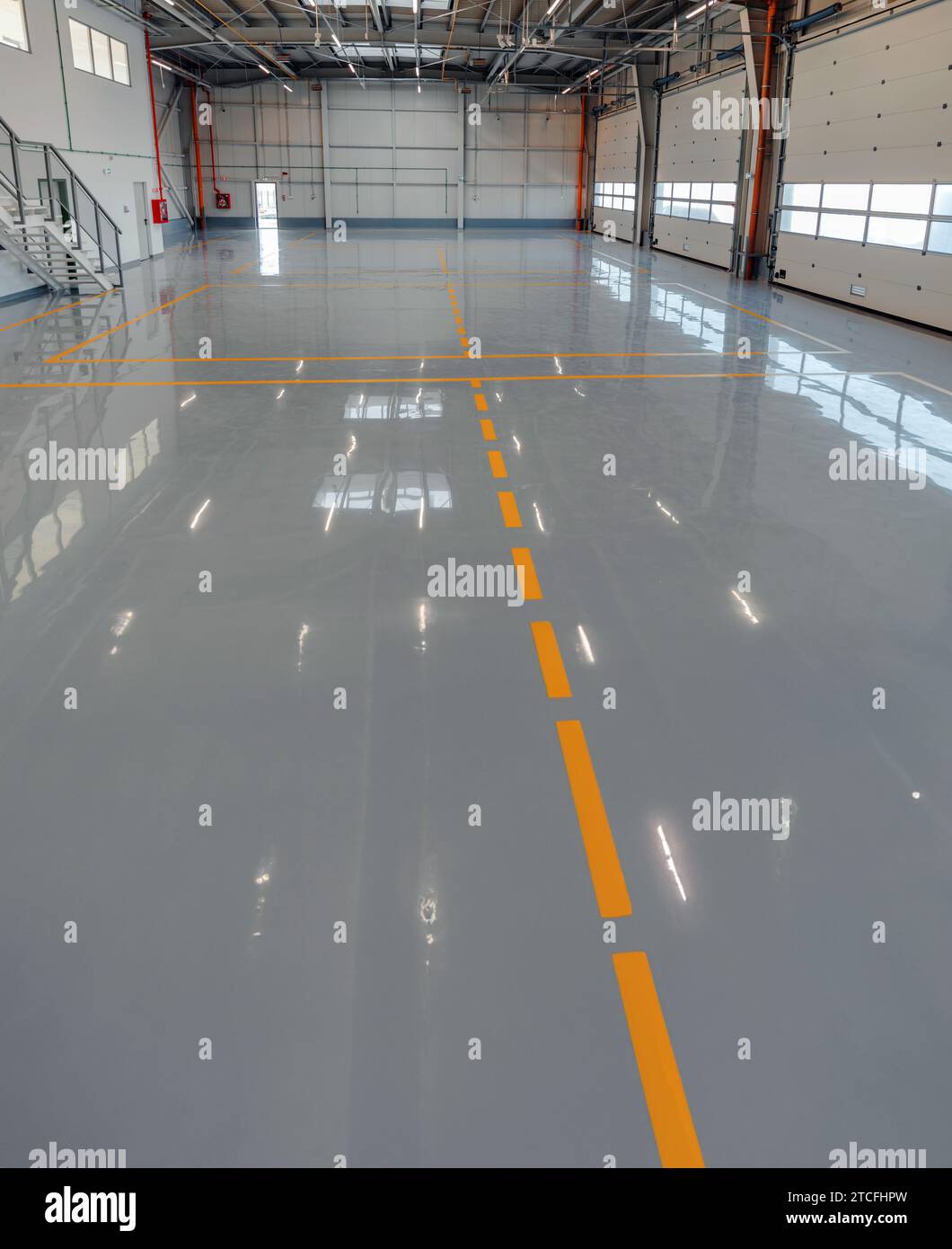 This image shows a large industrial warehouse with a glossy epoxy paint ...