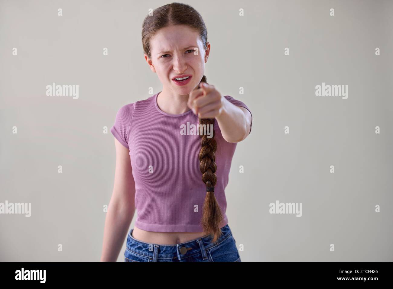 Studio Portrait Of Angry And Frustrated Teenage Girl Shouting At Camera ...
