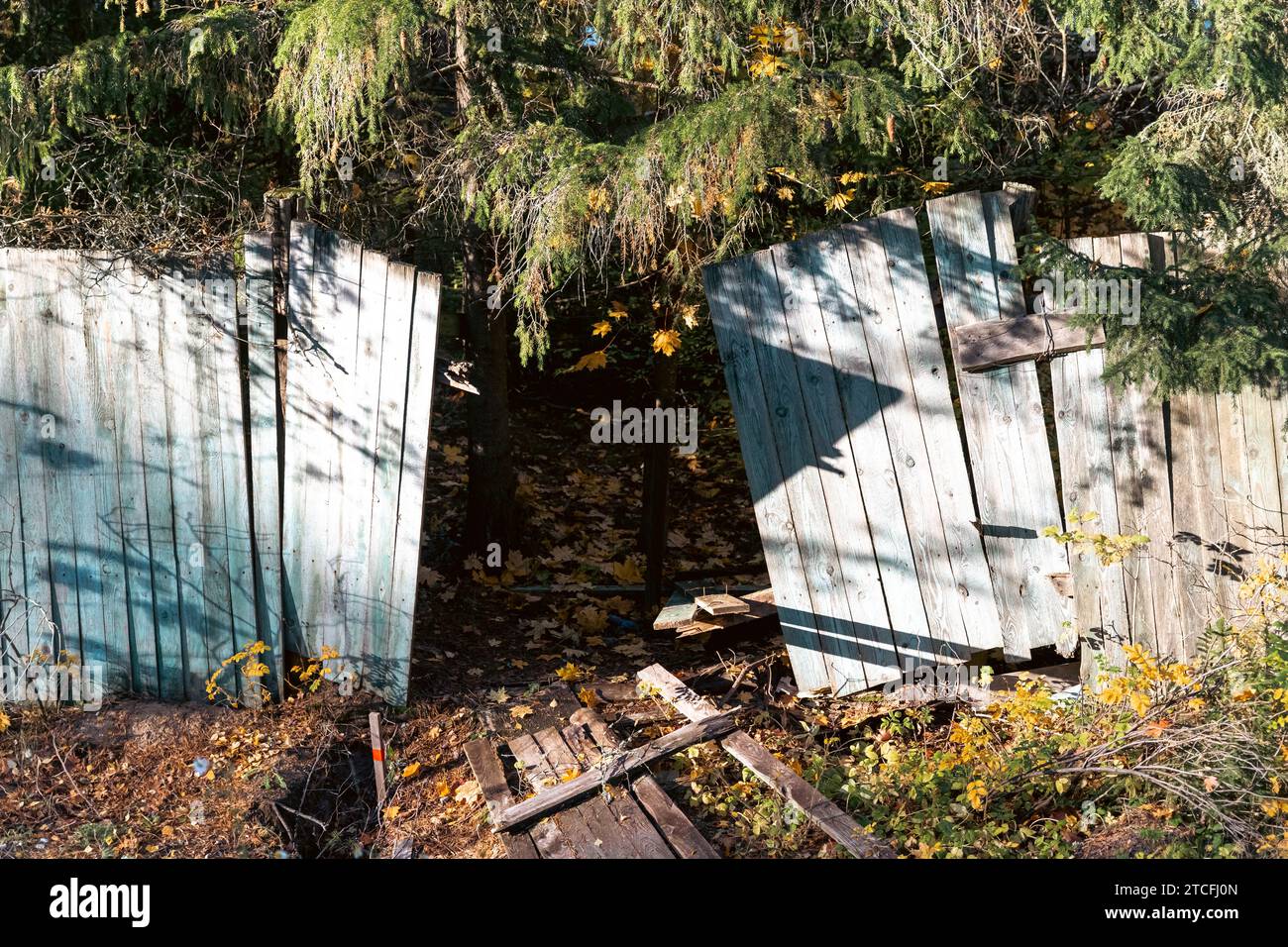 A weathered, rustic wooden fence with a gate, symbolizing time and ...
