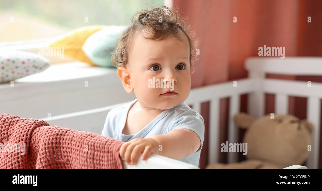 Cute little baby in crib Stock Photo - Alamy