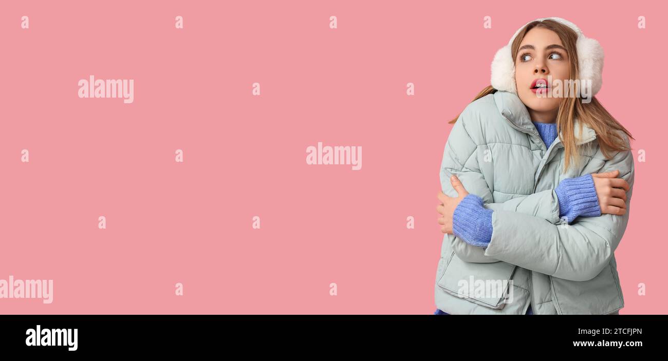 Freezing young woman in winter clothes on pink background with space ...