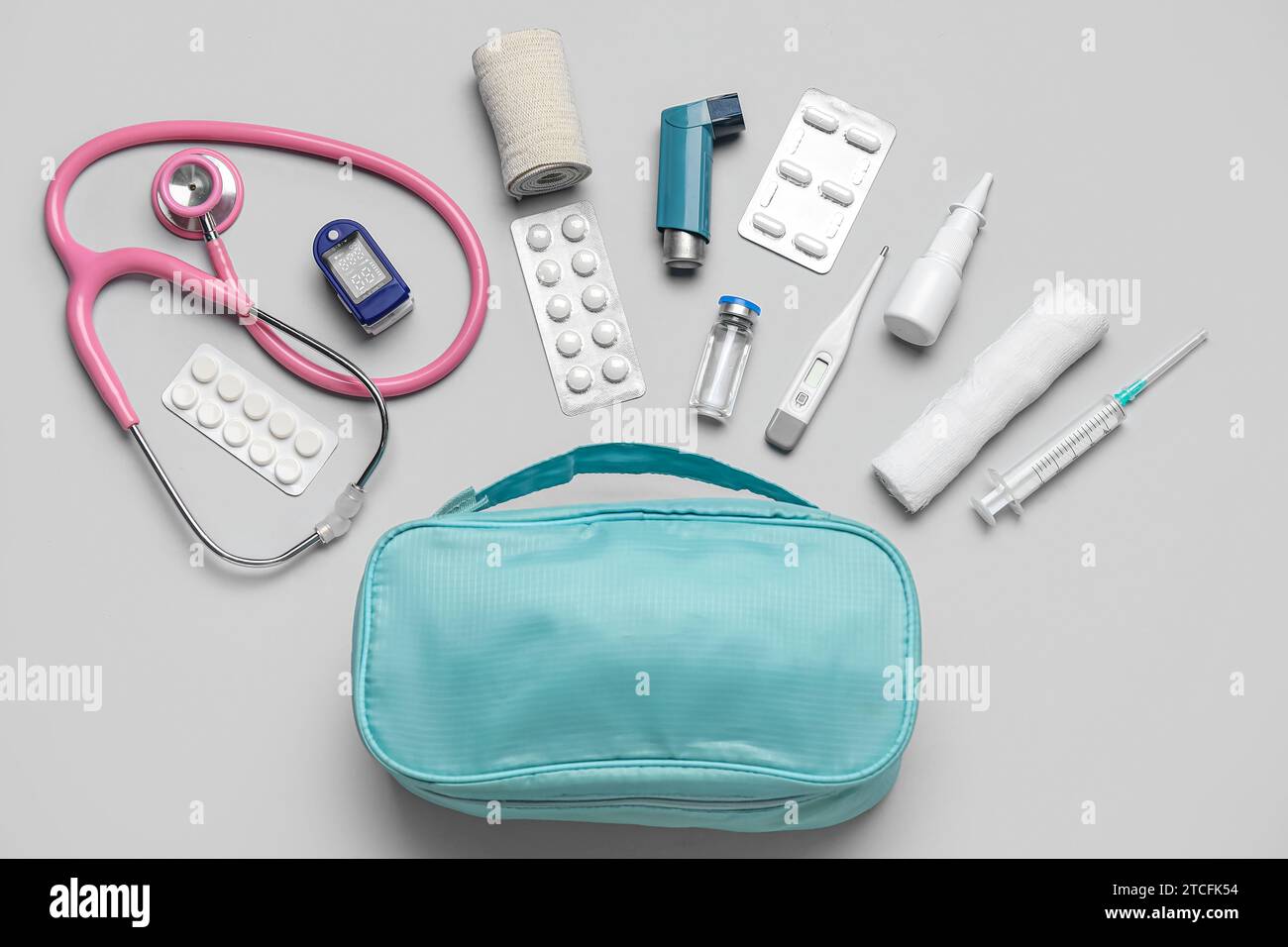 First aid kit and pills on grey background Stock Photo - Alamy