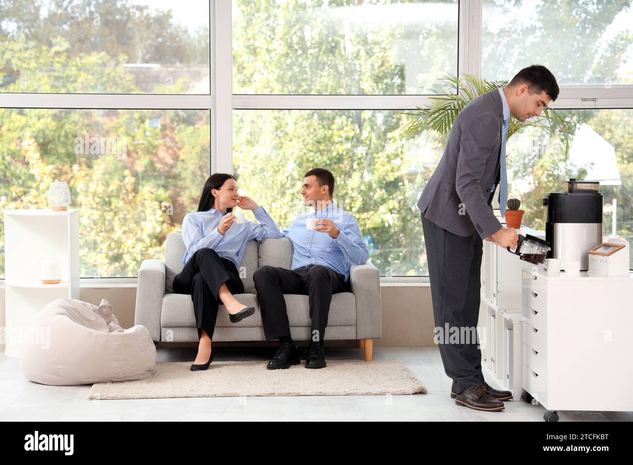Business colleagues having coffee break in office Stock Photo - Alamy
