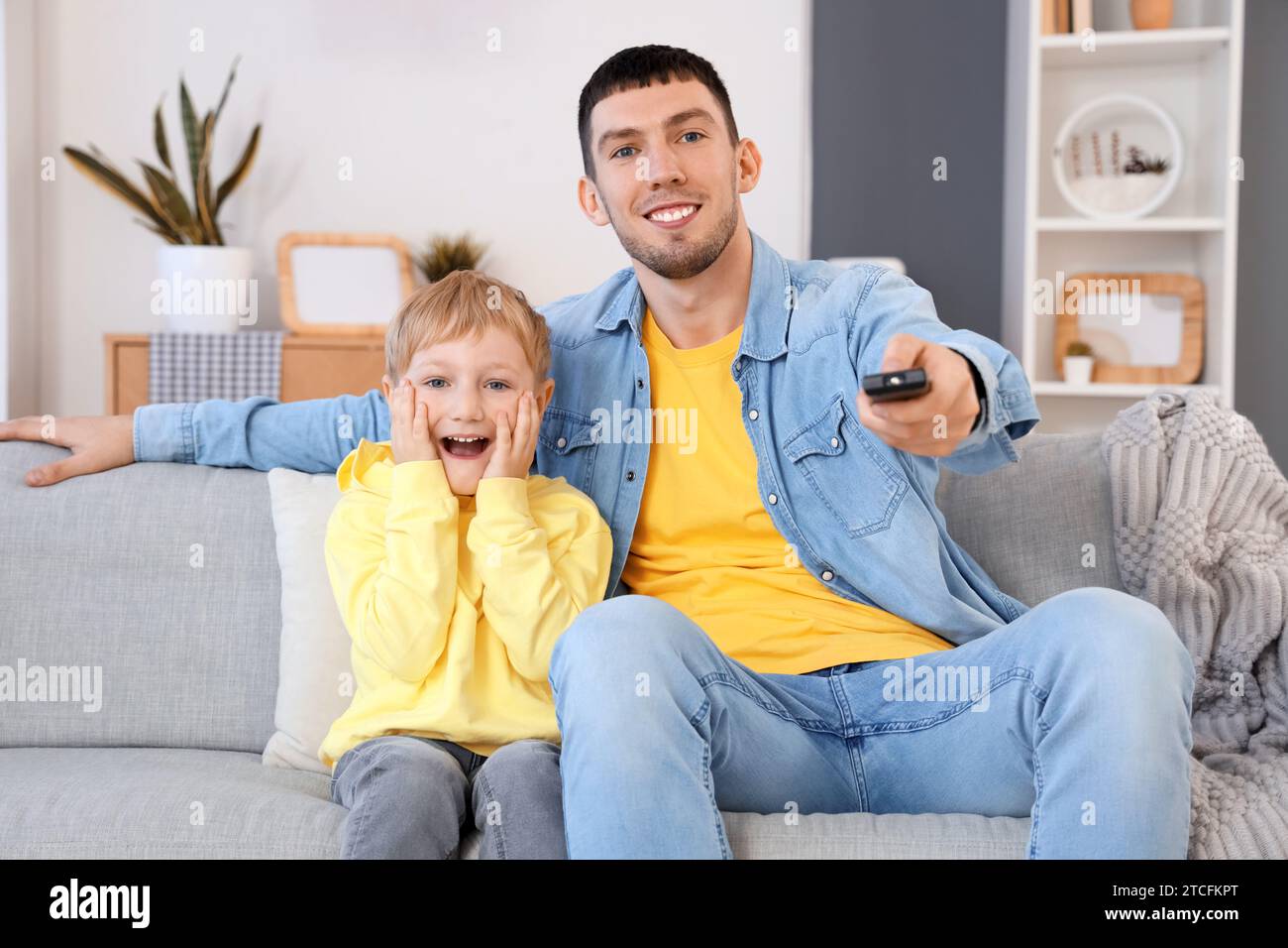 Little boy with his father watching TV at home Stock Photo - Alamy