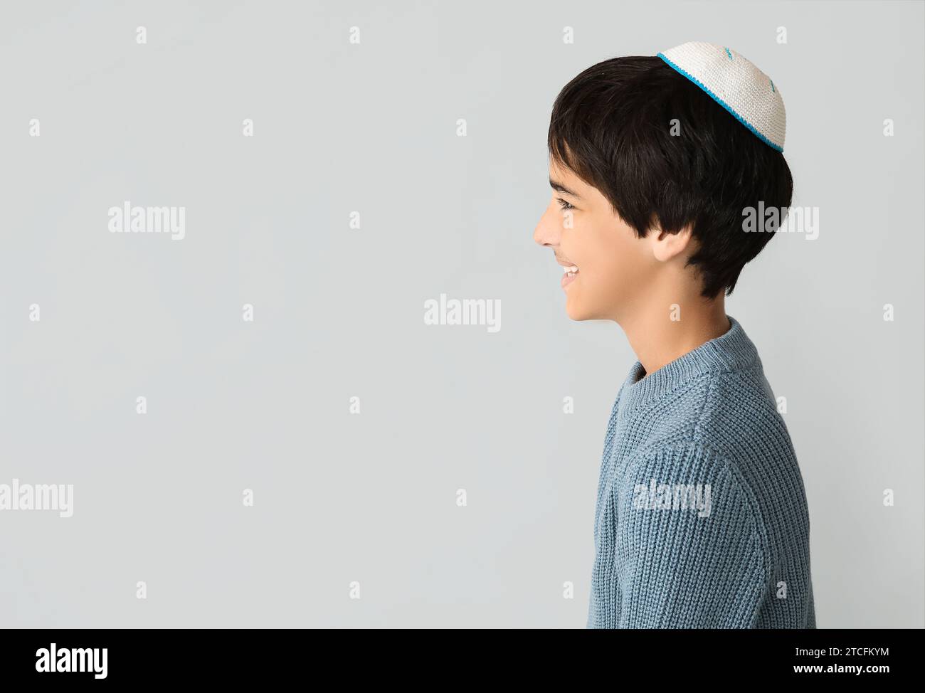Little Israeli boy in kipa on grey background Stock Photo - Alamy