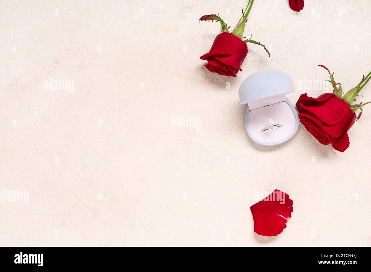Beautiful engagement ring and rose flowers on white background ...