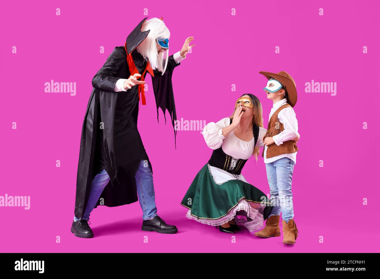 Father in vampire costume scaring his family in carnival masks on ...