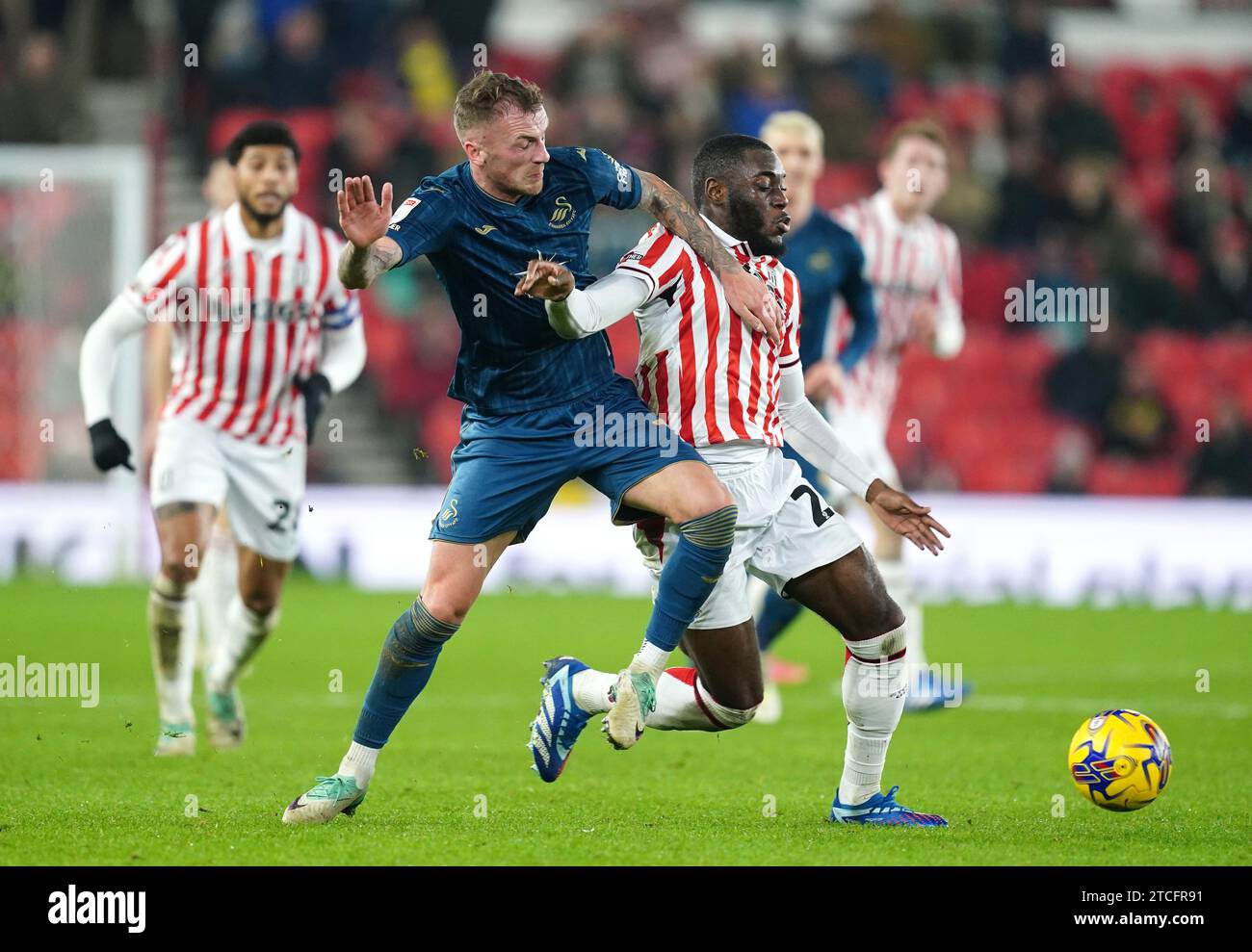 Swansea City's Josh Tymon (left) and Stoke City's Junior Tchamadeu ...