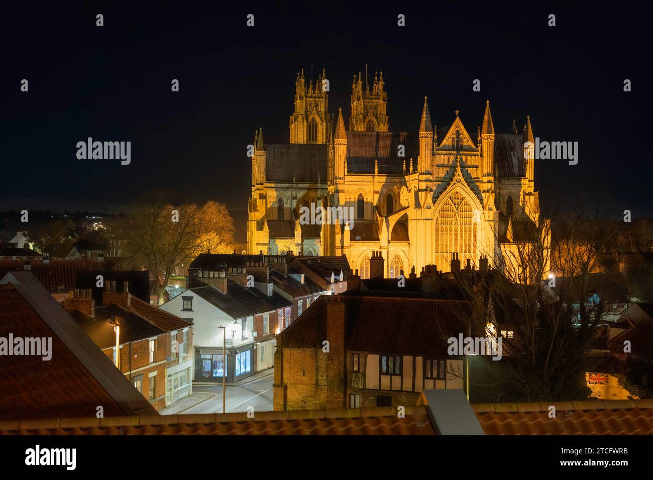 Night time view of ancient minster from elevated point in town centre ...
