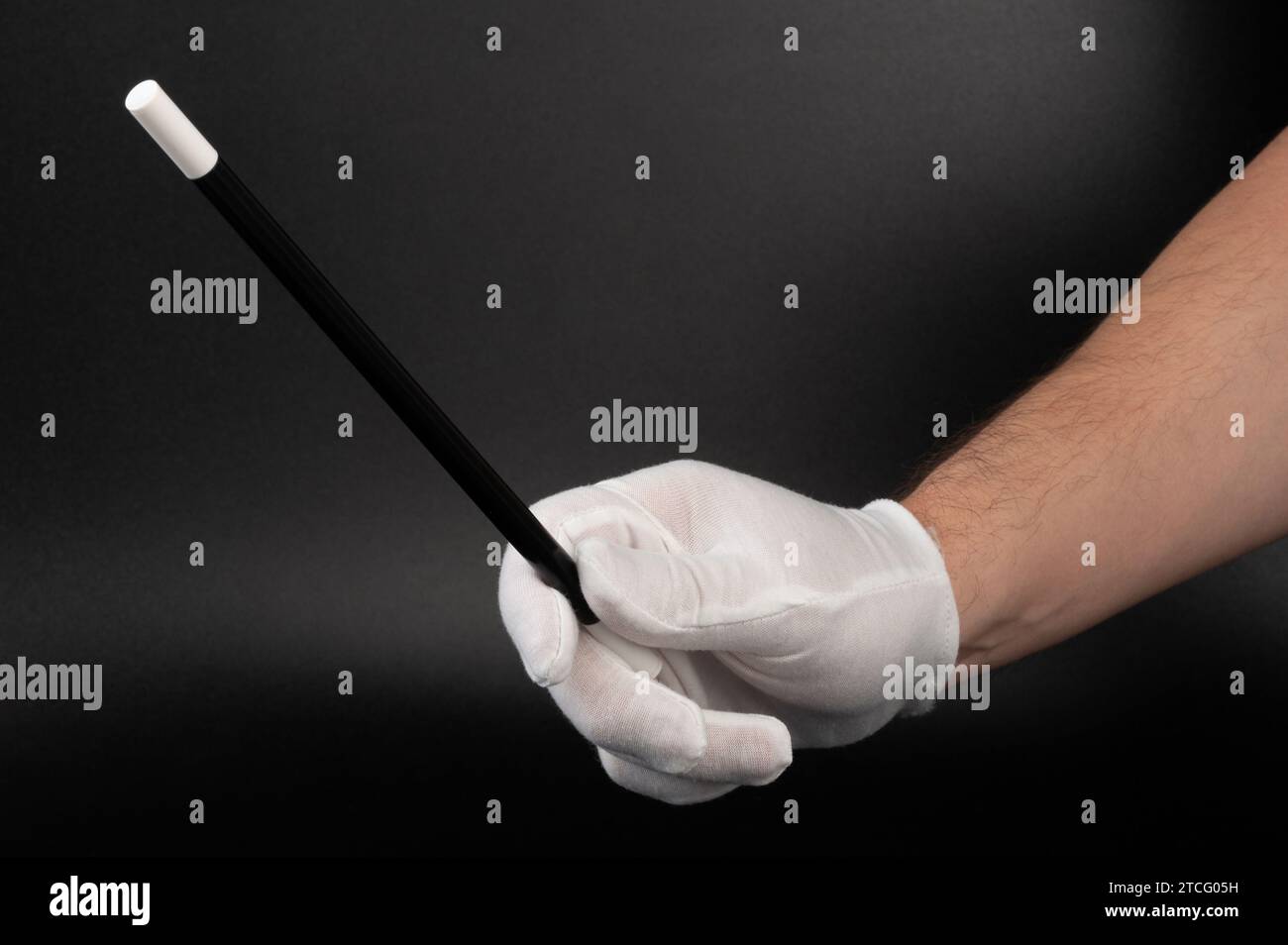 Hand hold magic wizard wand close up view on black background Stock ...