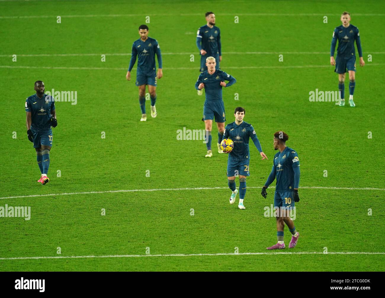 Swansea City players dejected after Stoke City's Daniel Johnson (not ...