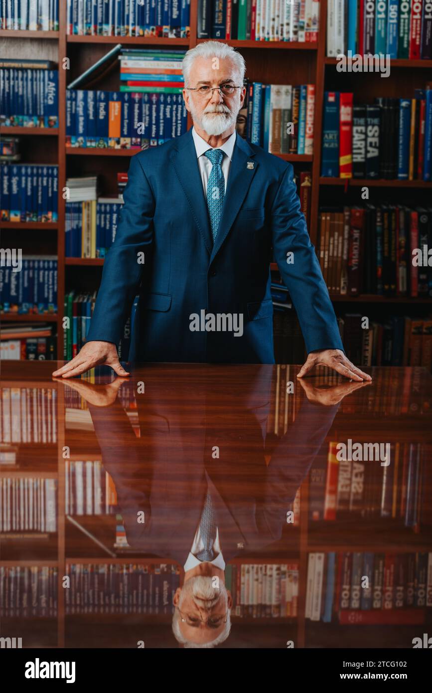 Experienced University Rector Posing Confidently with Books in Library ...