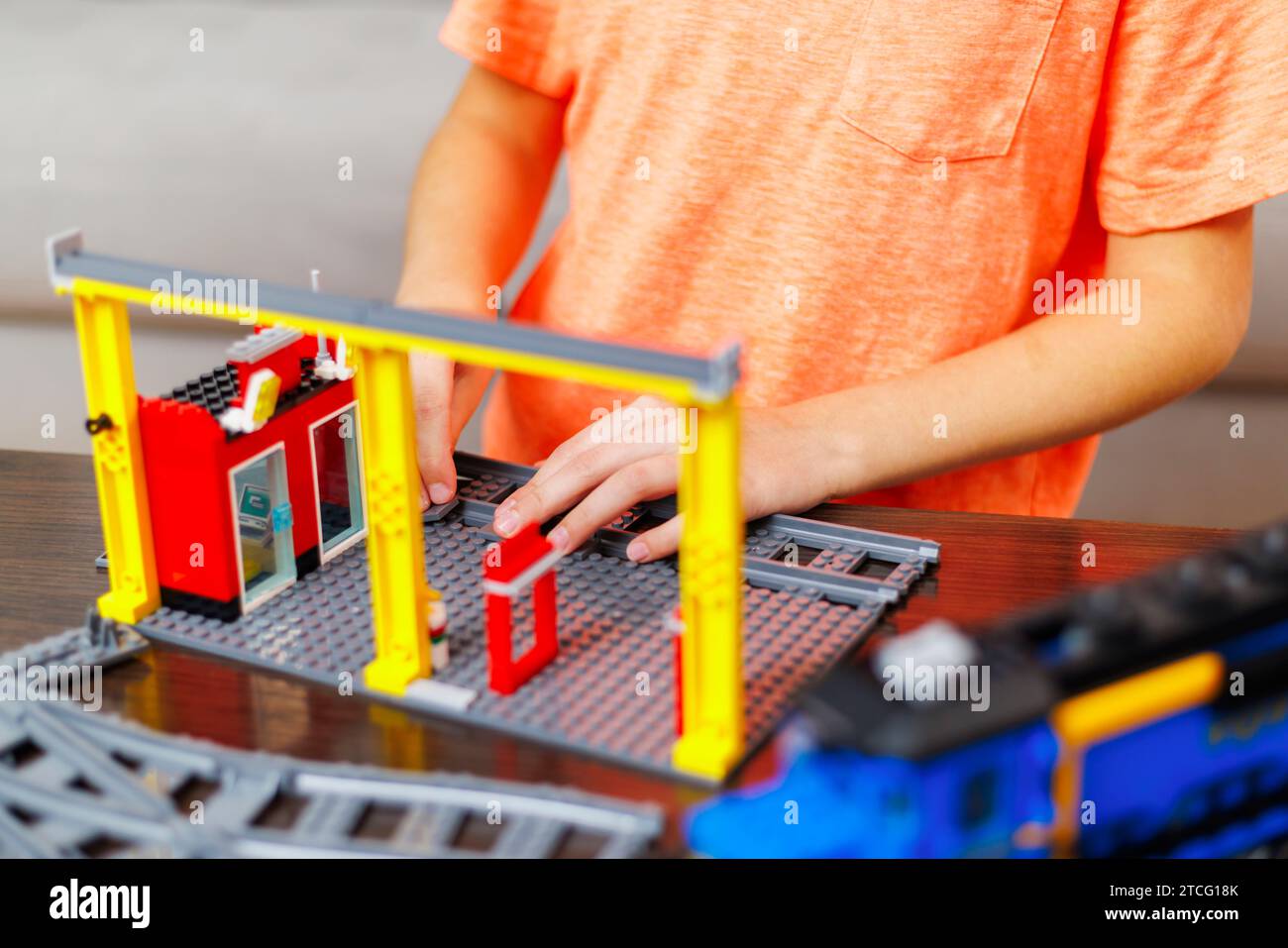 Child boy playing and building with colorful plastic bricks at the ...