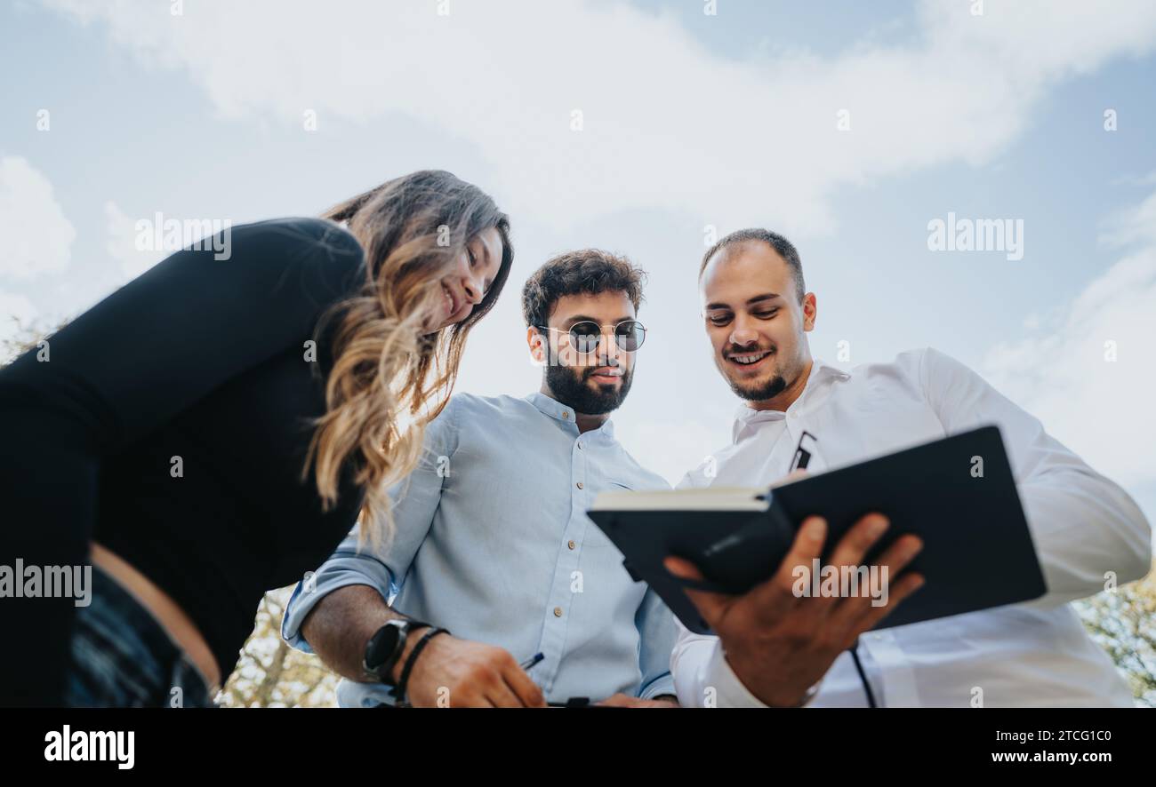 Students collaborate outdoors to achieve academic success through ...