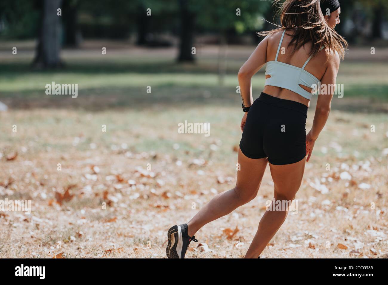 Attractive Girl Throwing Rugby Ball in a Sunny Park Stock Photo - Alamy