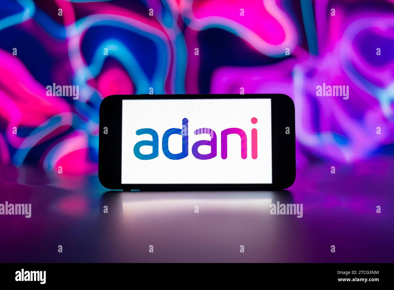 In this photo illustration, the Adani group logo is seen displayed on a ...