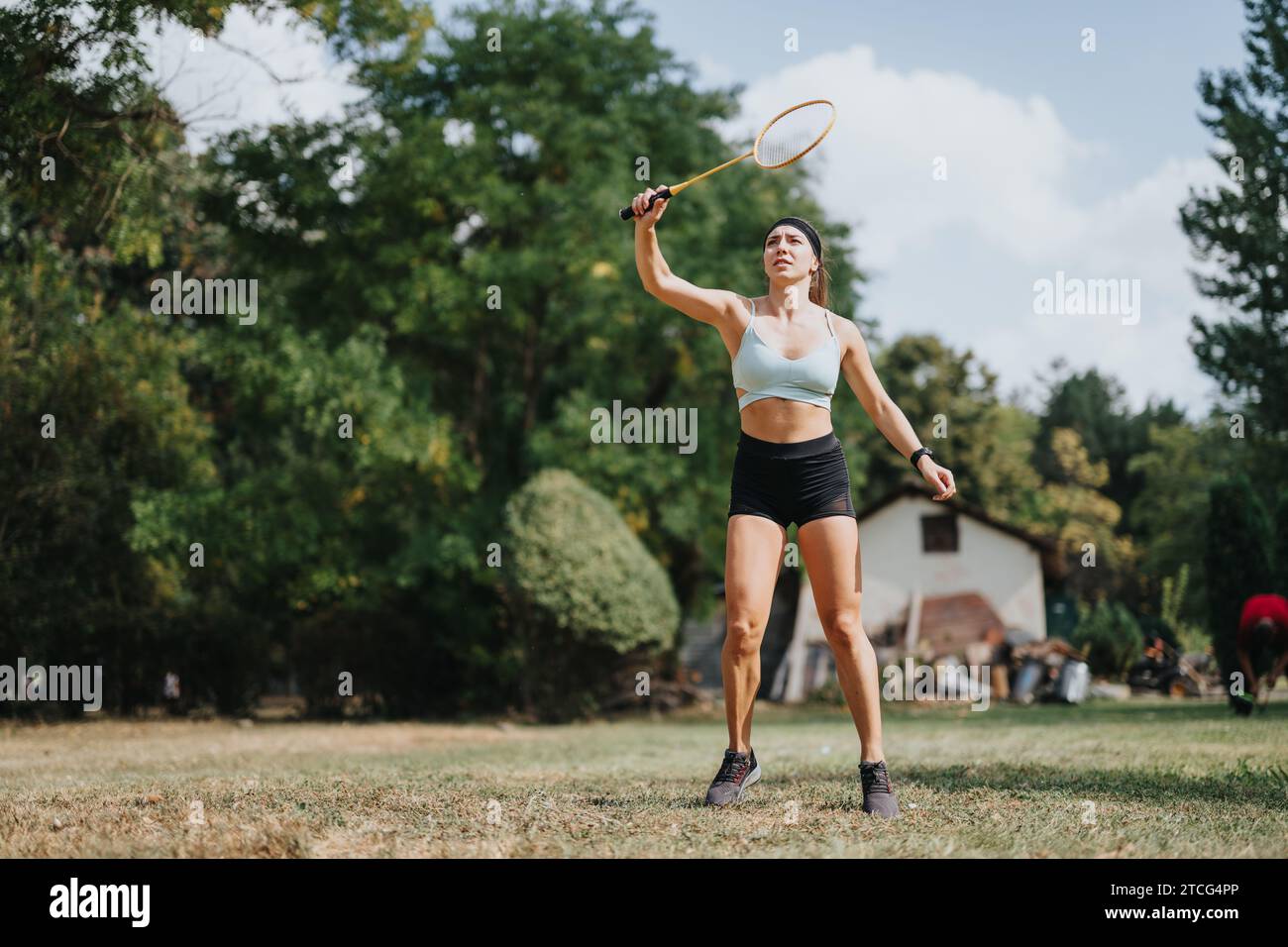 Fit athlete playing badminton outdoors, having fun and training Stock ...