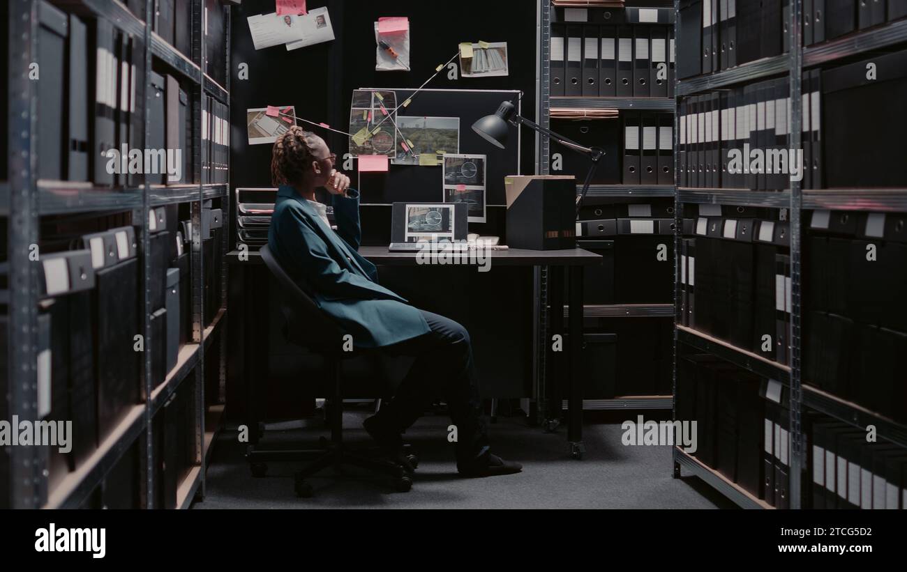 Private inspector examining clues and records, conducting criminal ...