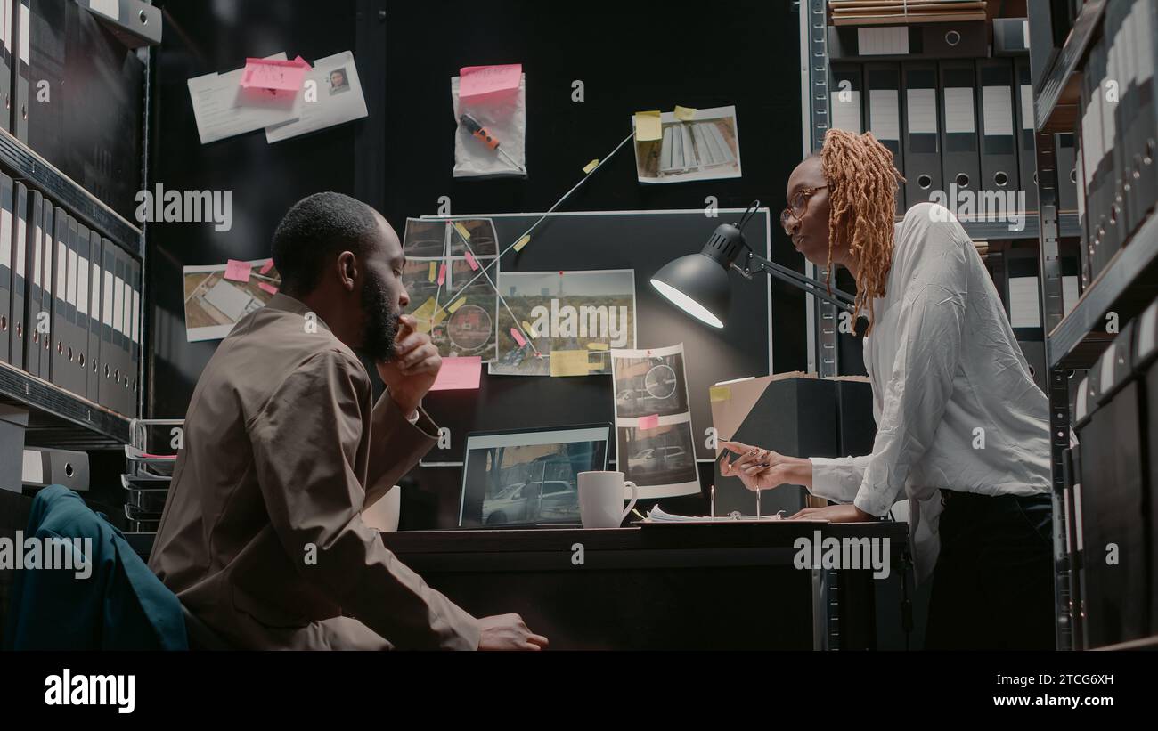 Detectives team looking at evidence board on wall, police officers ...