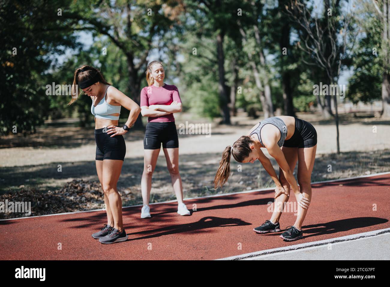 Active females enjoying outdoor sports, running and training together ...