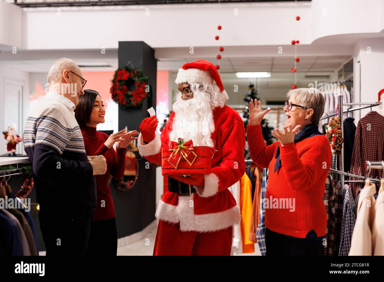 Young man presenting contest winners in clothing store, reading names ...