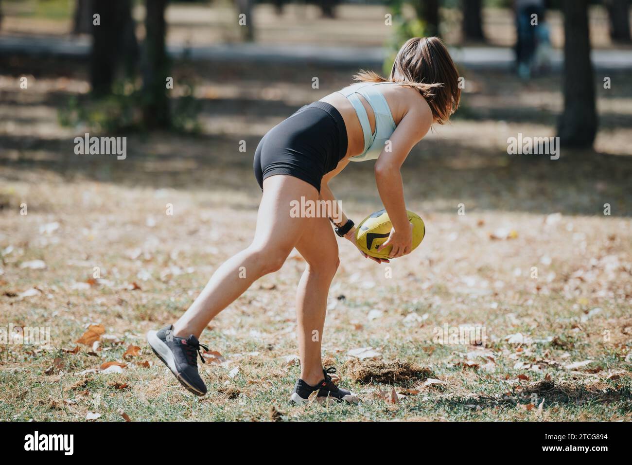 Energetic athletes having fun in a city park, playing outdoor sports ...