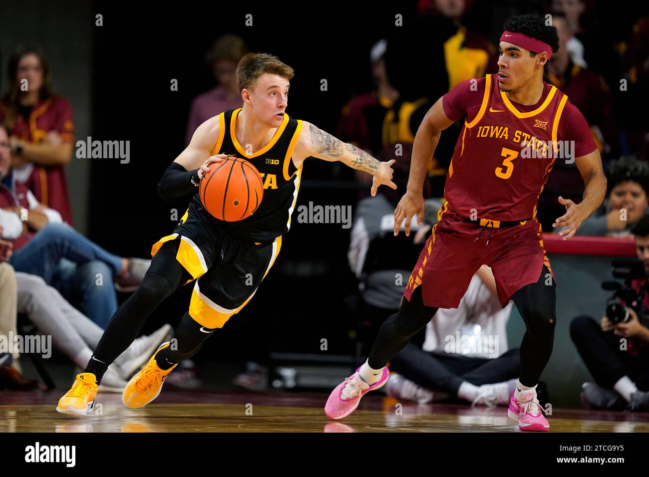 Iowa guard Brock Harding, left, drives past Iowa State guard Tamin ...