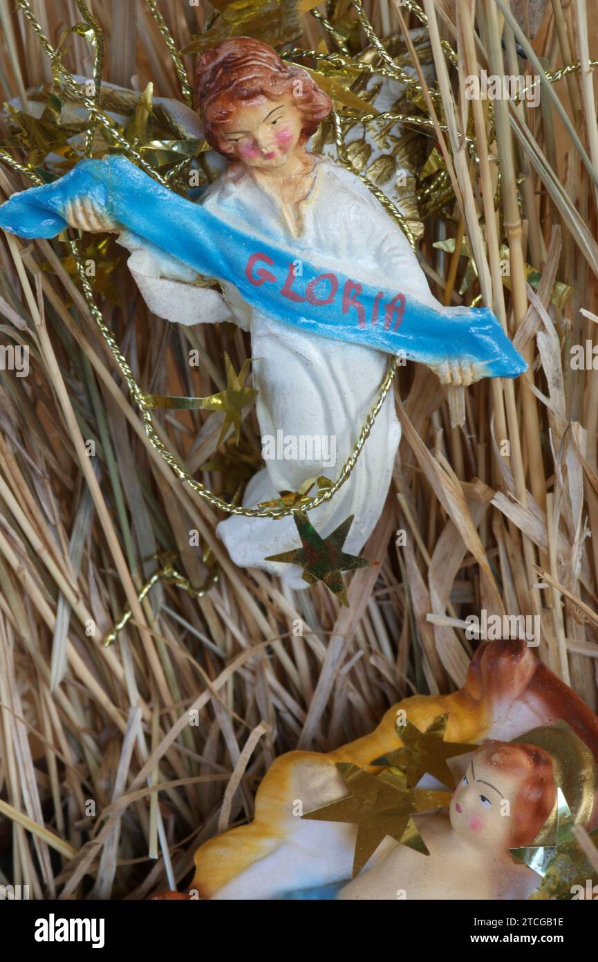 Christmas announces Jesus birth. Angel figure holds a banner Gloria ...