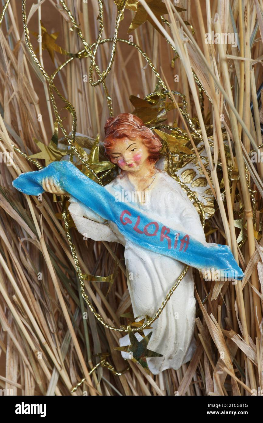 Christmas announces Jesus birth.Vintage plaster angel holds a banner ...